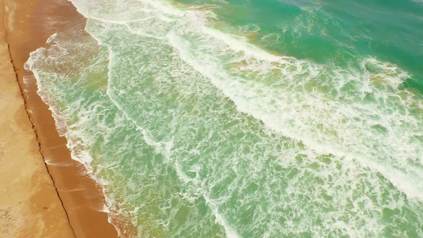 Aerial Drone Footage Of Sea Waves Crashing On Shore. Slow Zoom Out Shot ...