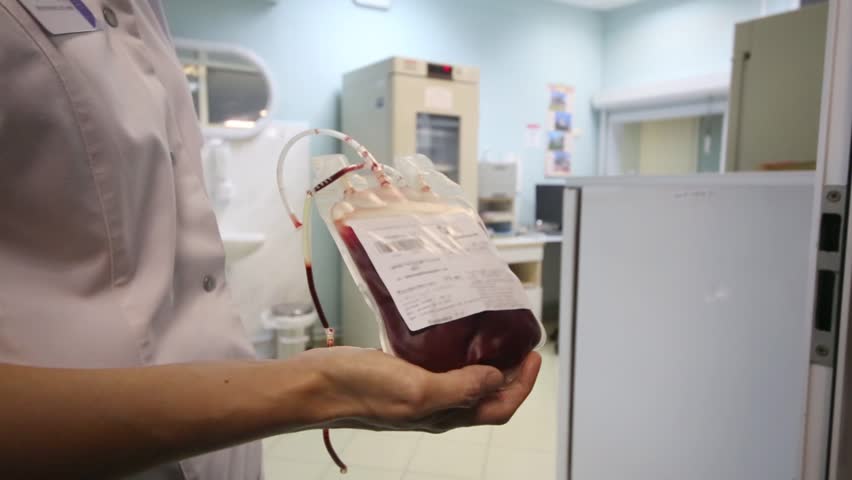 Stock Video Clip of Female doctor holds package with frozen red ...