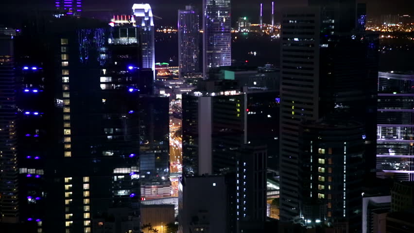 Ascending Night View To The Top Of High Rise City Buildings From Lower ...