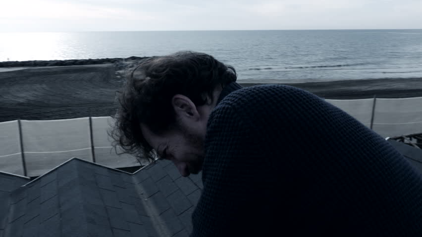 Closeup Of Sad Lonely Man Crying In Front Of The Ocean Camera Moving ...