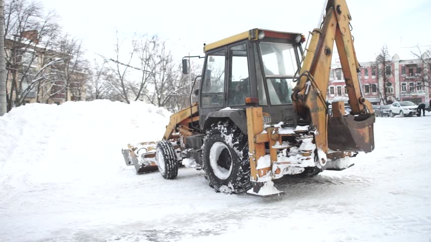 Bulldozer Pushing Deep Snow Off Mountain Road Near Forest In Central ...