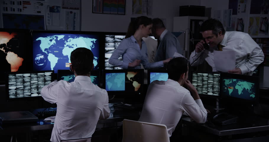 A Busy Team Of Security Personnel Are Manning The Stations Within A ...