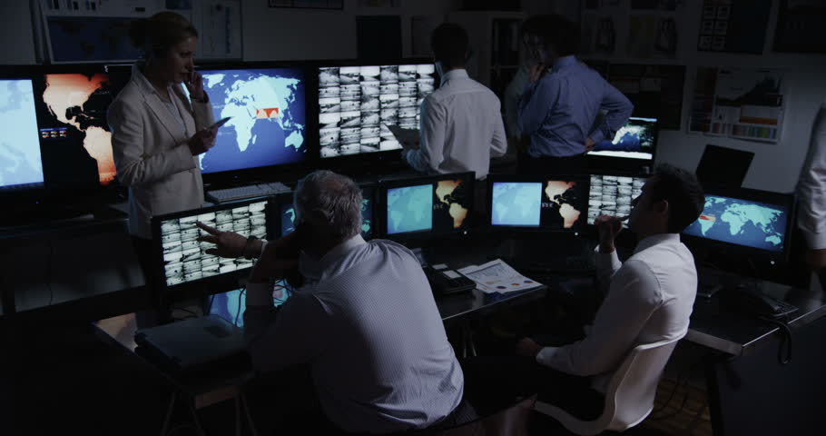 A Busy Team Of Security Personnel Are Manning The Stations Within A ...