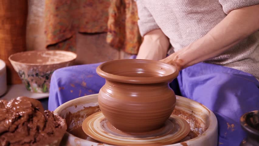 Stock Video Clip of Experienced potter creating traditional clay pot ...