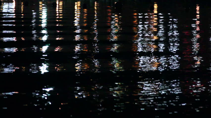 Stock Video Clip of Light color reflection on water at night | Shutterstock