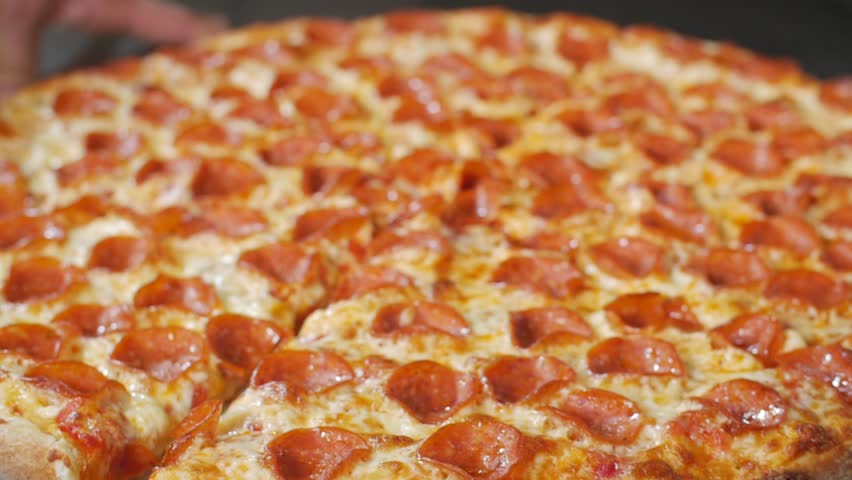 Slow Motion Close-up Of Drooping Slice Of Pepperoni Pizza Cooked In ...