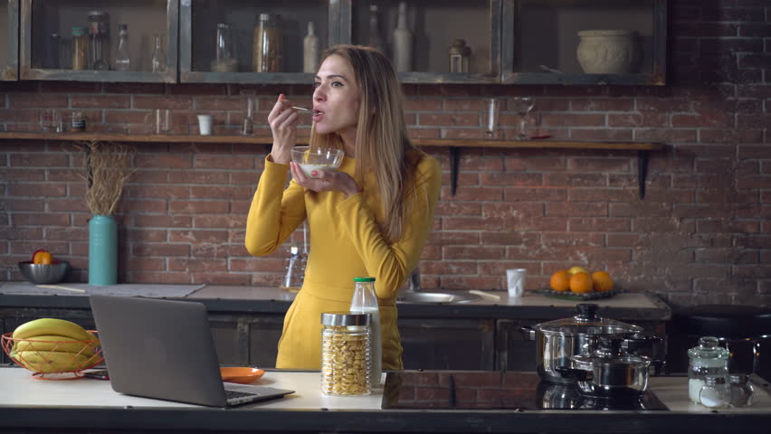 Happy Lady Cooking Breakfast In Kitchen. Smiling Redhead Female Prepare ...