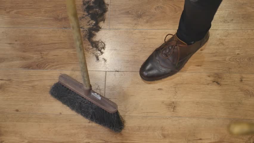 Hairdresser Sweeping Hair Clippings On Floor In Barber Shop. Stock ...