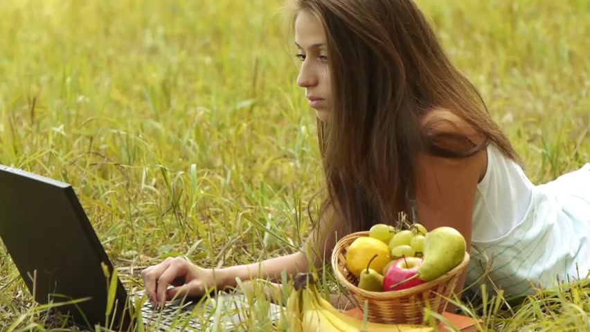 The Young Beautiful Girl On Meadow Writes To Notebook Stock Footage ...