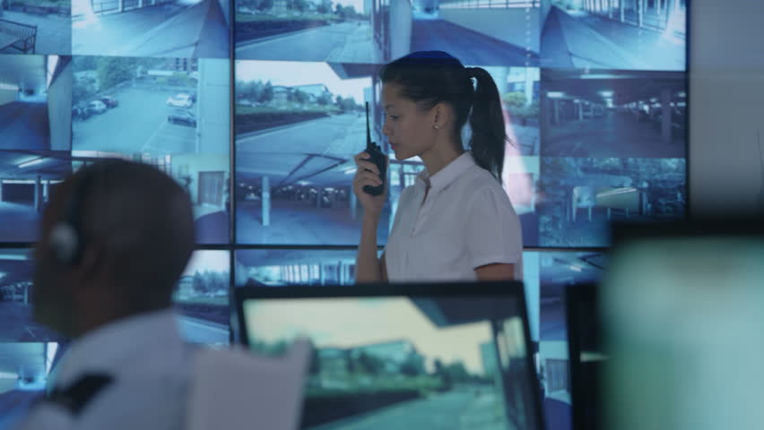 Back View Of The IT Engineer Working With Multiple Monitors Showing Graphics, Functional Neural ...