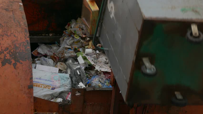 Trash Spilling Out Of Overfilled Trash Plastic Bag On City Street Stock ...