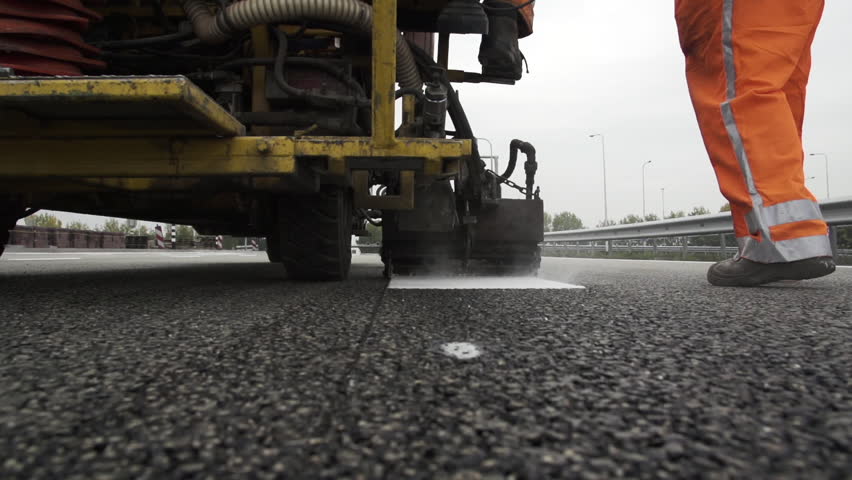 Asphalt Paver Applying Asphalt On The Highway. An Equipment Used To ...