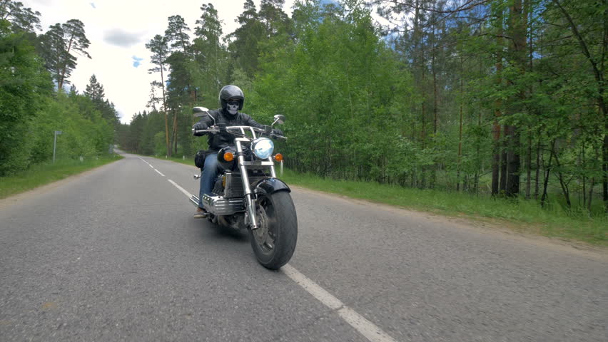 A Biker Riding A Customized Motorcycle On An Open Road Stock Footage ...