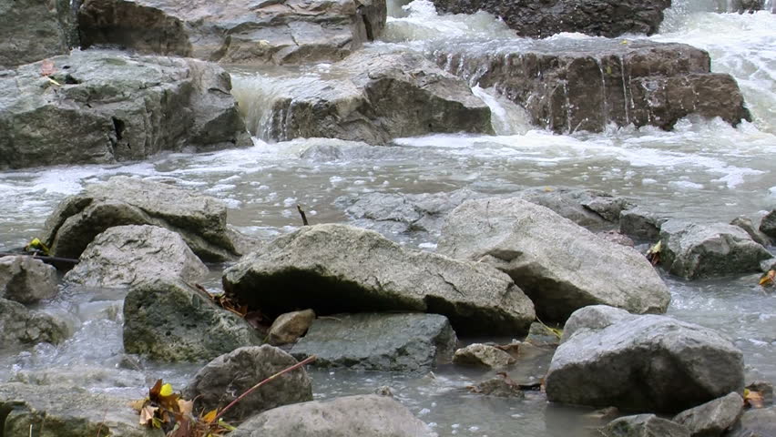 Close-up Of Muddy Water After A Heavy Down Pour Flowing Over Large ...