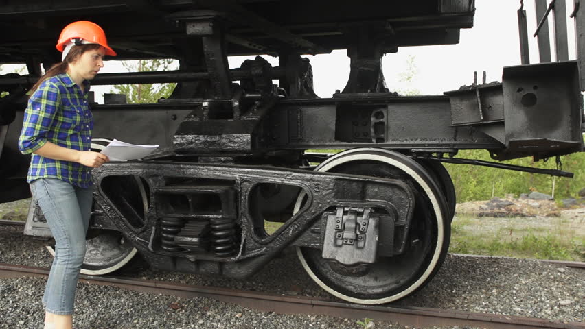 Stock Video Clip of A young brunette woman railway worker in | Shutterstock