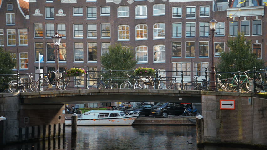 Amsterdam Canal Bridge With Cycling Bicycles, Bikes. Dutch Houses ...