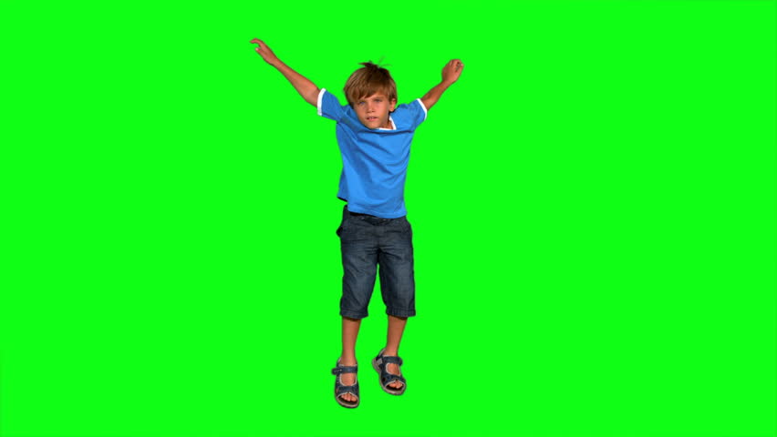 Boy jumping on green screen in slow motion