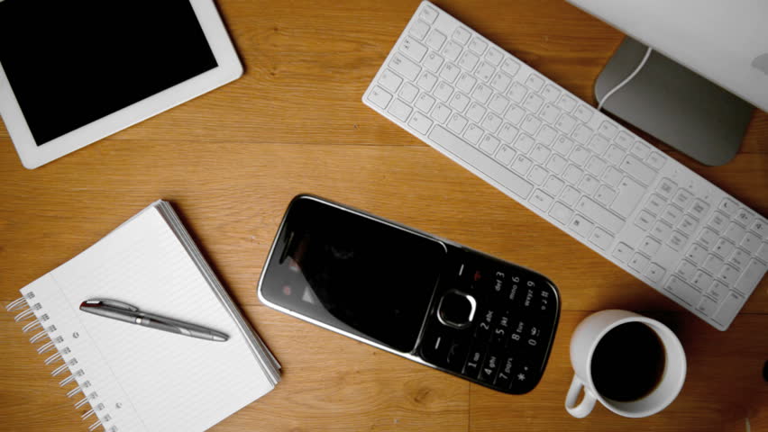 Stock video of mobile phone falling onto office desk | 3808583 ...