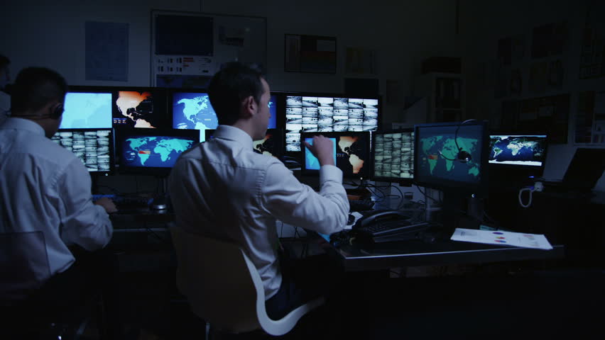 A Busy Team Of Security Personnel Are Manning The Stations Within A ...