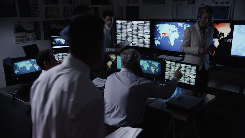 A Busy Team Of Security Personnel Are Manning The Stations Within A ...