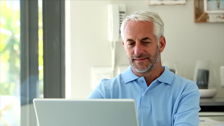 Handsome Elderly Senior Man Working On Laptop Computer At Home. Remote ...