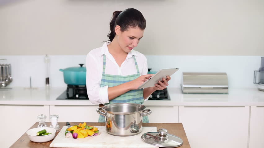 Stock Video Clip of Beautiful brunette following a recipe on her ...