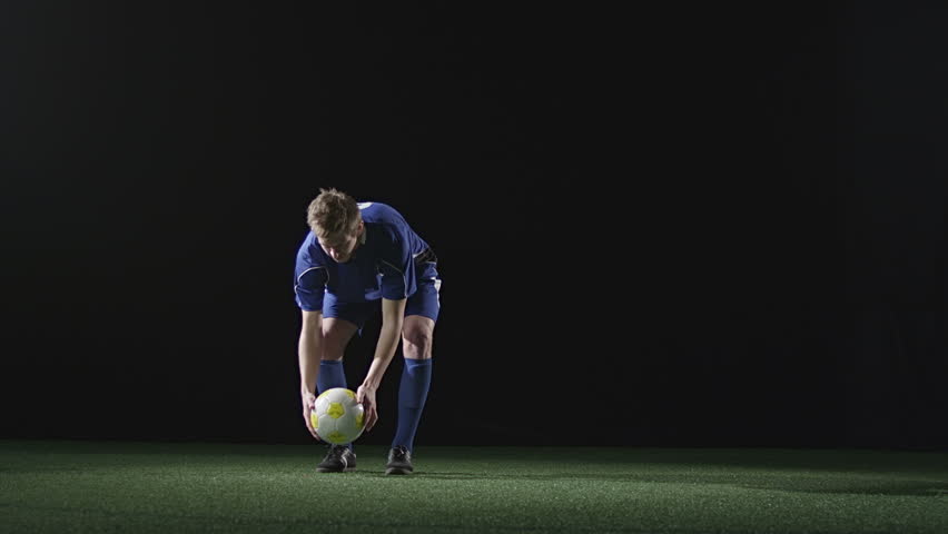 A Soccer Player Runs Up To The Camera And Then Kicks The Ball Out Of ...