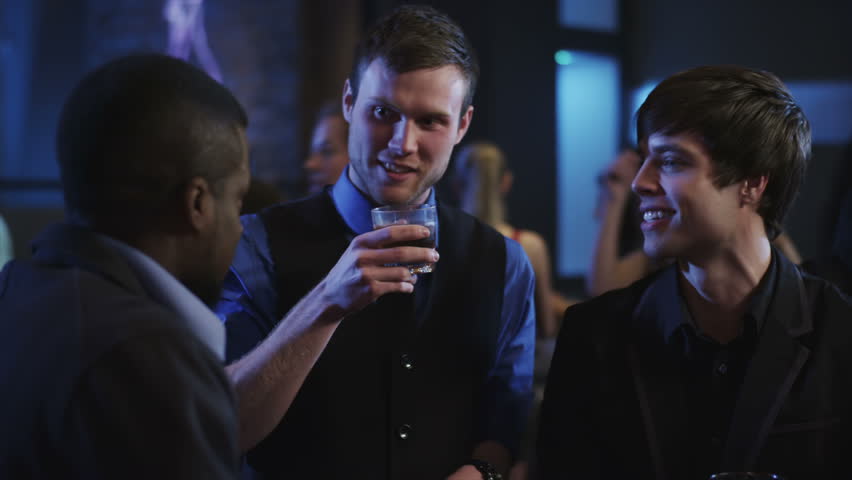 Stock Video Clip of A group of men hang out at | Shutterstock