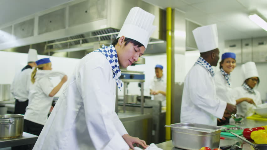 Team Of Chefs In A Professional Kitchen Doing Dishes And Cleaning The ...