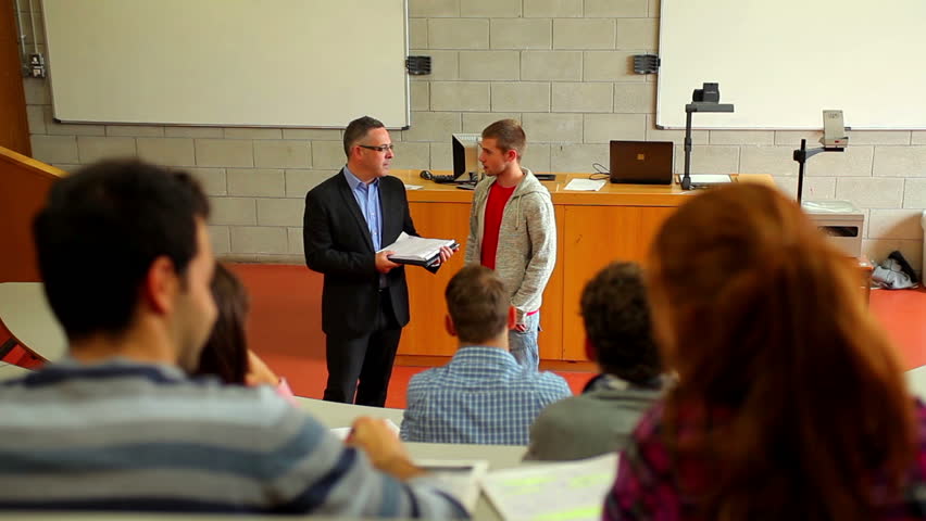 Stock video of student talking to lecturer in lecture | 5276513 ...