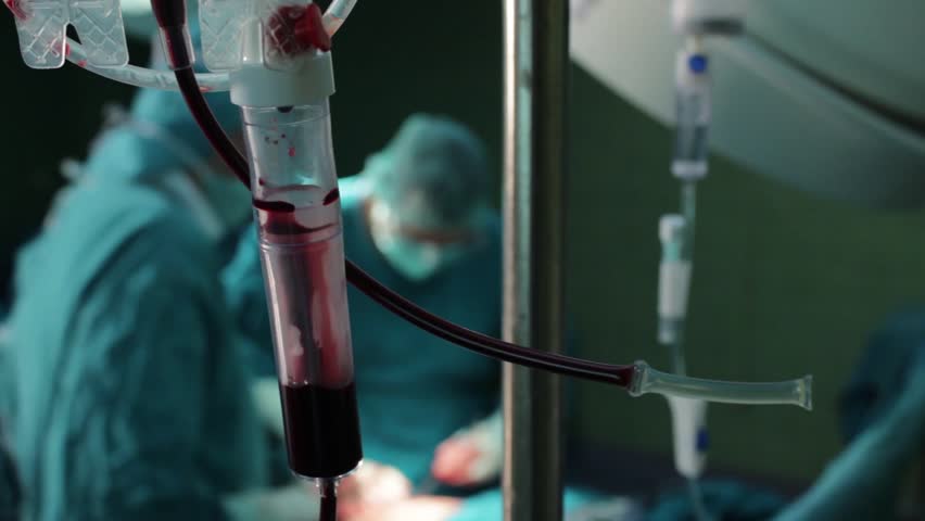 Intravenous Drip In Focus,surgeons Team Performing Operation In The ...