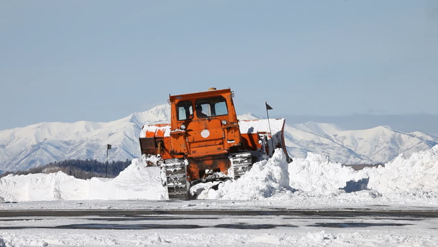 Bulldozer Pushing Deep Snow Off Mountain Road Near Forest In Central ...