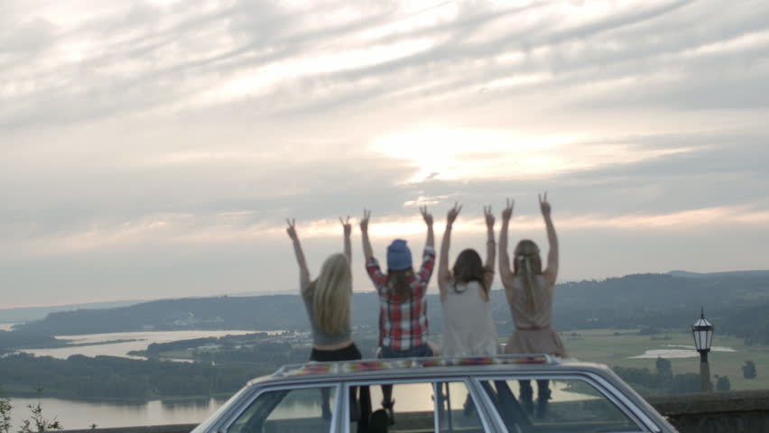 Stockvideo von 4 teenagers sit on roof of | 6991213 | Shutterstock