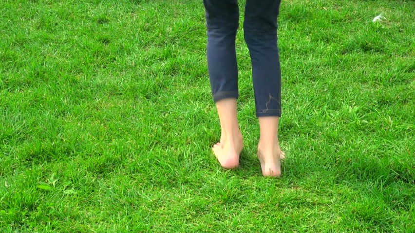 A Young Couple Is Running Around On The Grass And Is Madly In Love ...