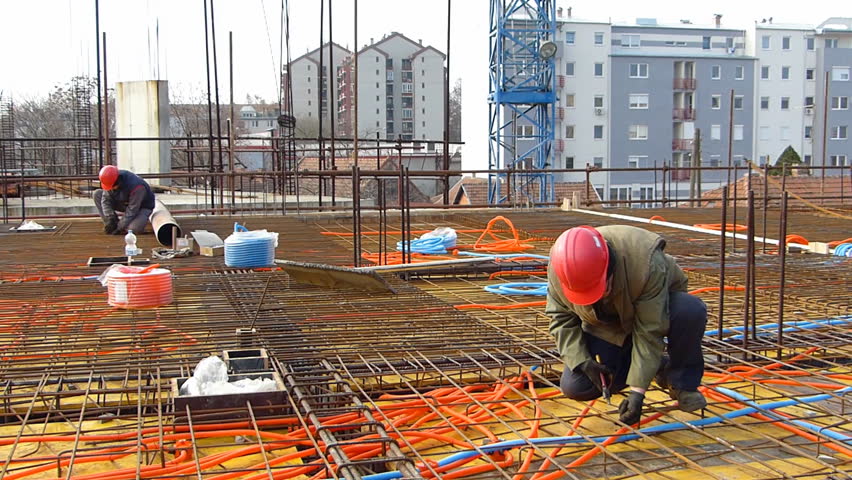 Stock video of construction workers installing reinforcement steel bars ...